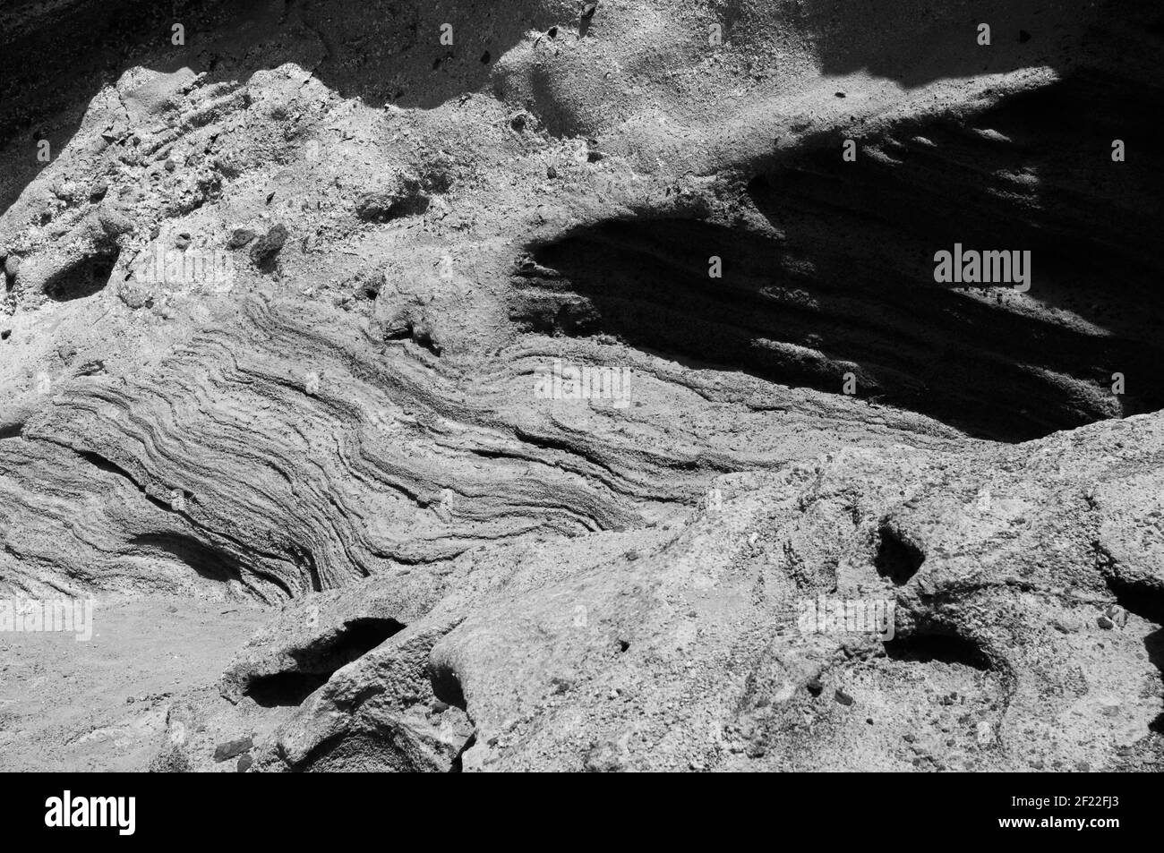 Washed out stone formation on a coast, the different sediments can be ...