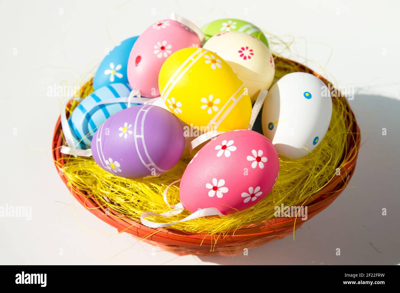 colorful easter eggs in basket isolated Stock Photo - Alamy
