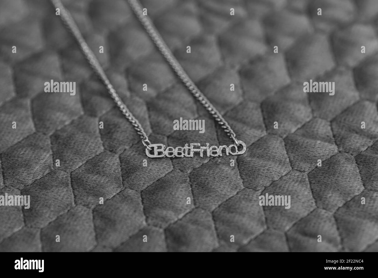 Best Friend Word Pendant necklace shoot in a sunny day outside closeup ...