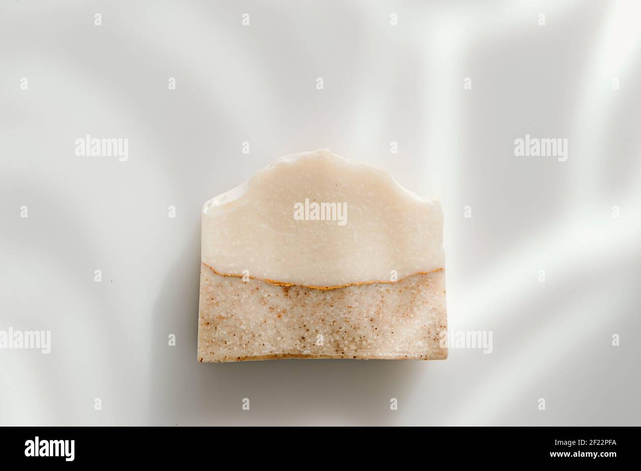 Handmade soap and sunshade shadow on white background. Zero waste, eco ...