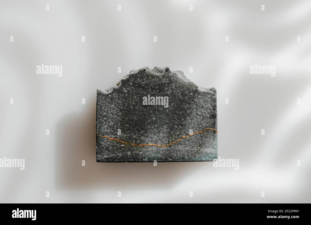 Handmade soap and sunshade shadow on white background. Zero waste, eco ...