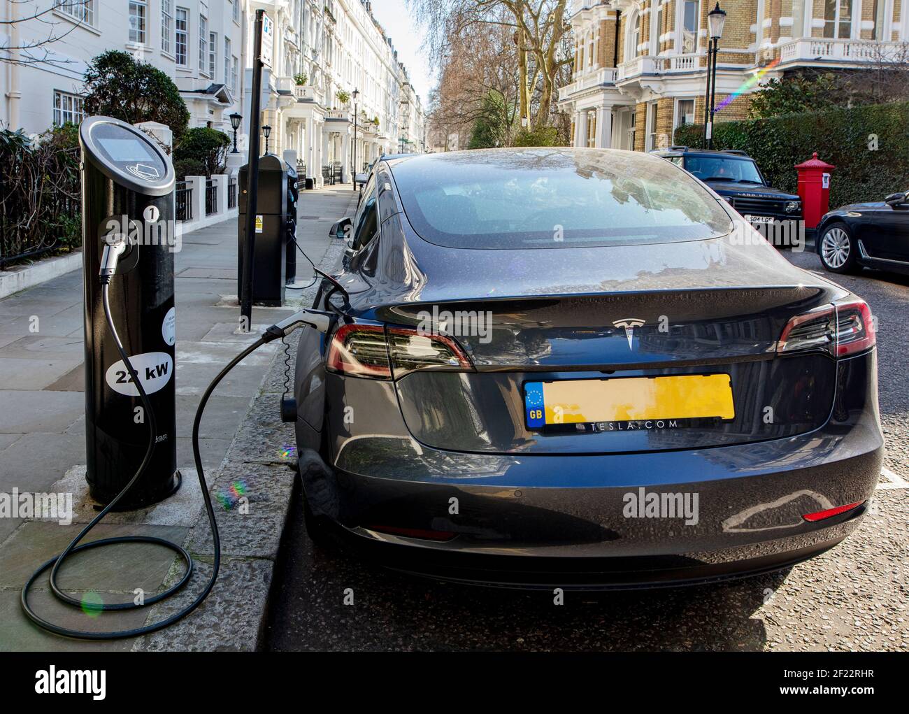 Tesla electric car being charged at a charging point in Kensington ...