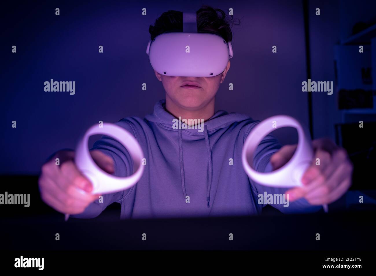 Teenager playing with virtual reality device. Cyberpunk futuristic mood ...