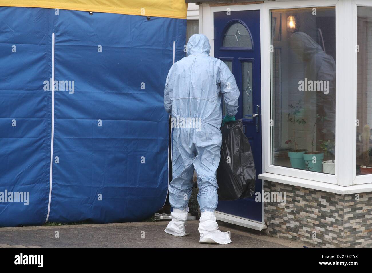 A forensic officer outside a house in Freemens Way in Deal, Kent, after ...