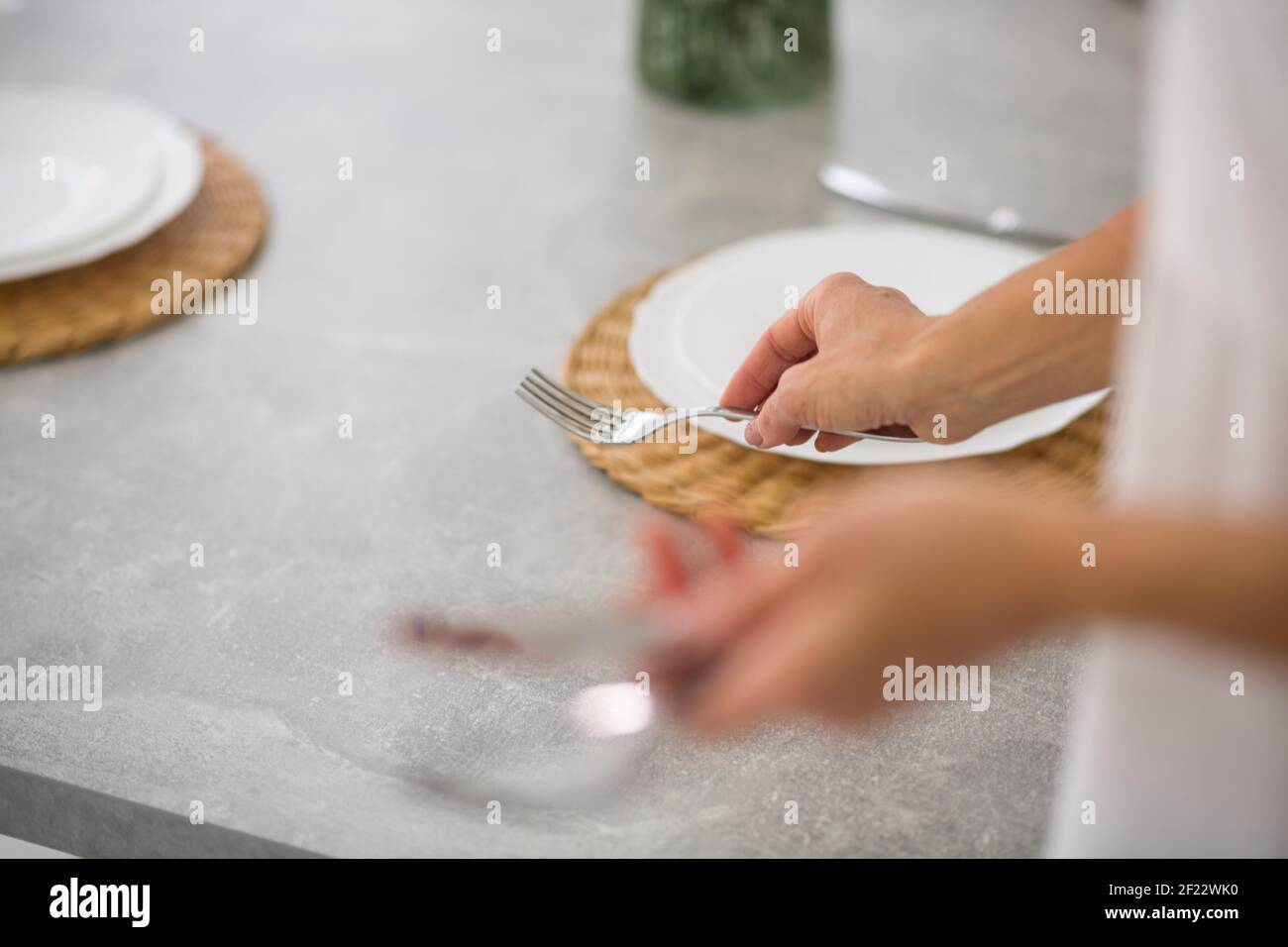 Close up of womans hands serving the table for dinner Stock Photo - Alamy