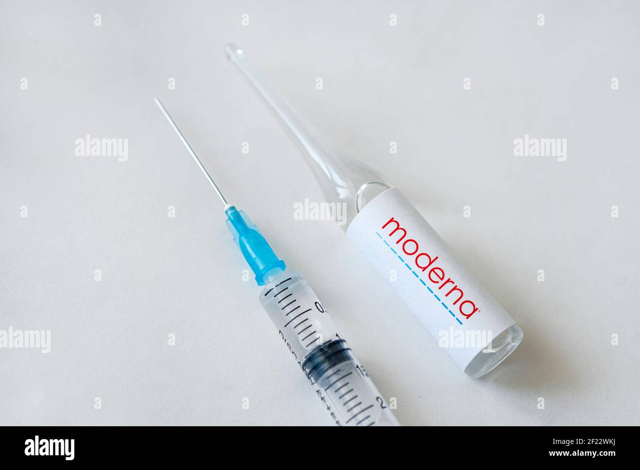 logo of the moderna company on a glass bottle with liquid for ...