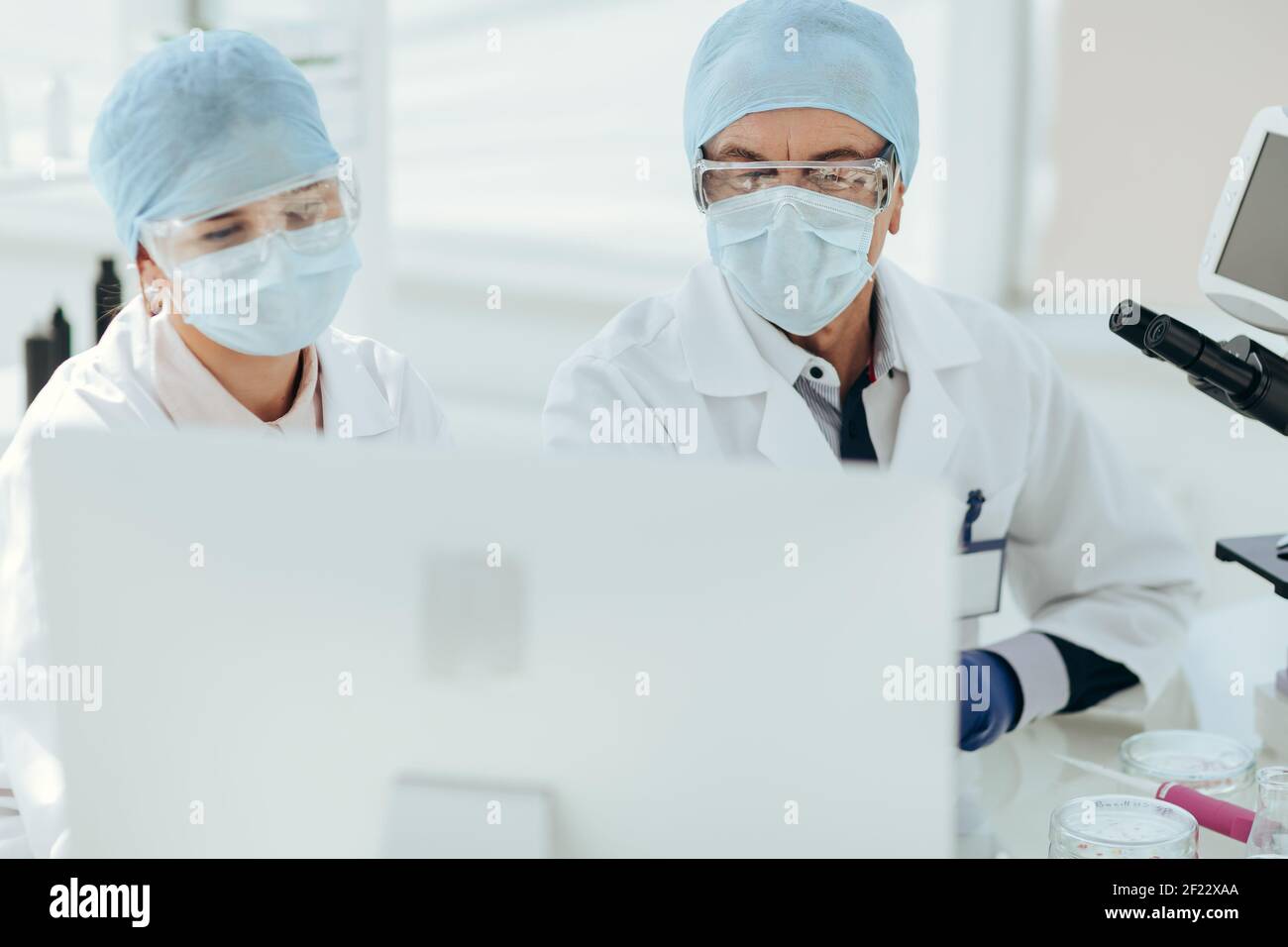 researchers discuss data from a computer monitor Stock Photo - Alamy