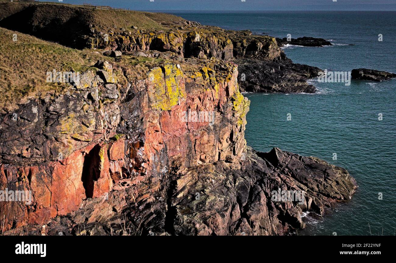 Colourful sea cliffs in afternoon winter sunshine Stock Photo - Alamy