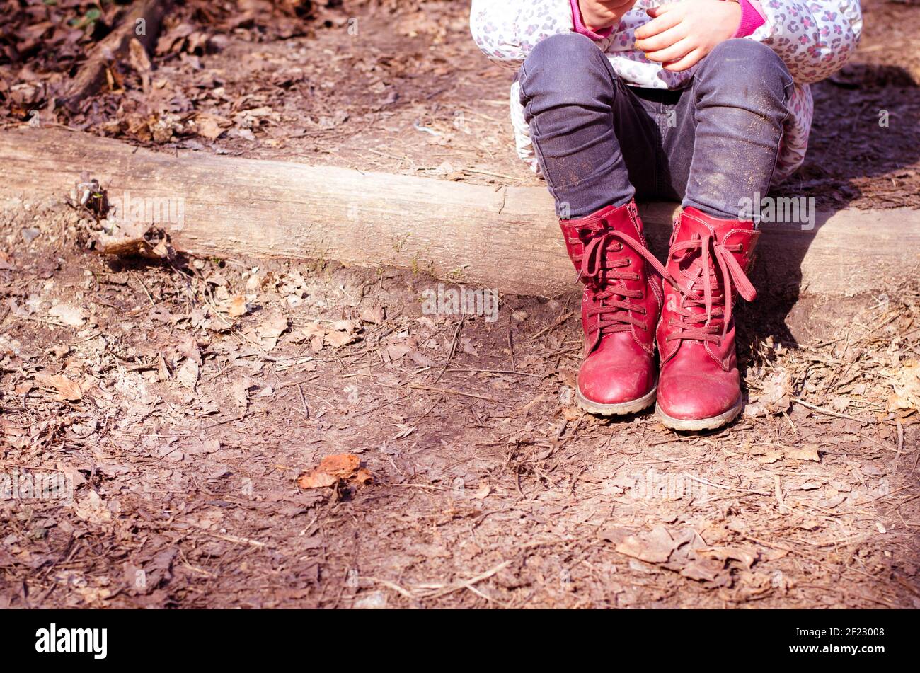 faceless child with red shoes and jeans sitting on stairs Stock Photo ...