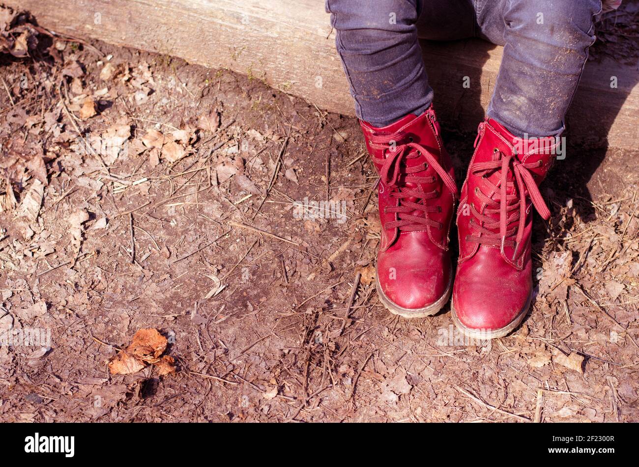 faceless child with red shoes and jeans sitting on stairs Stock Photo ...