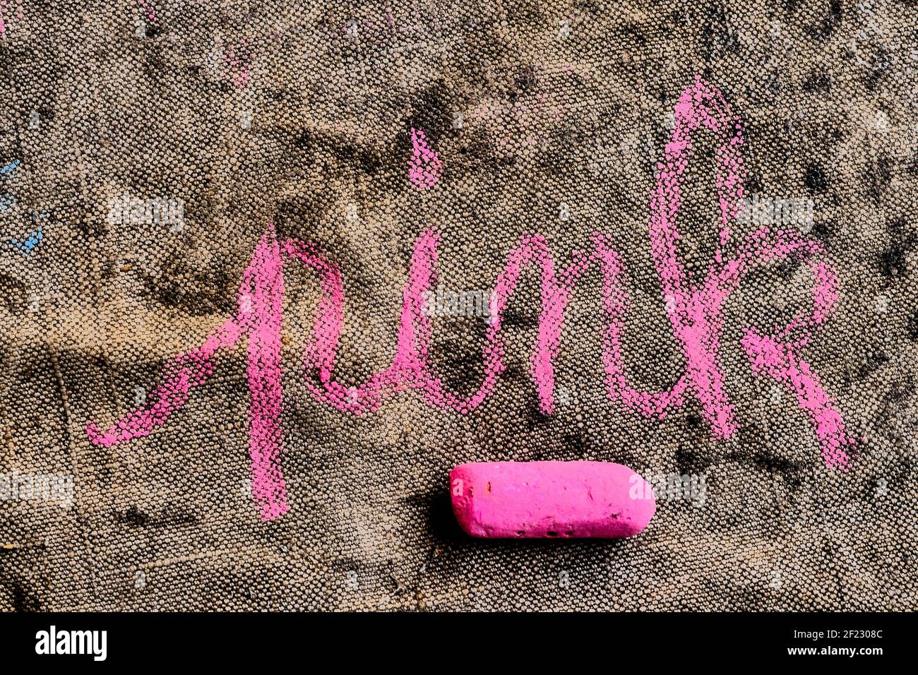 Pink chalk displayed on a canvas background, digitally filtered view ...