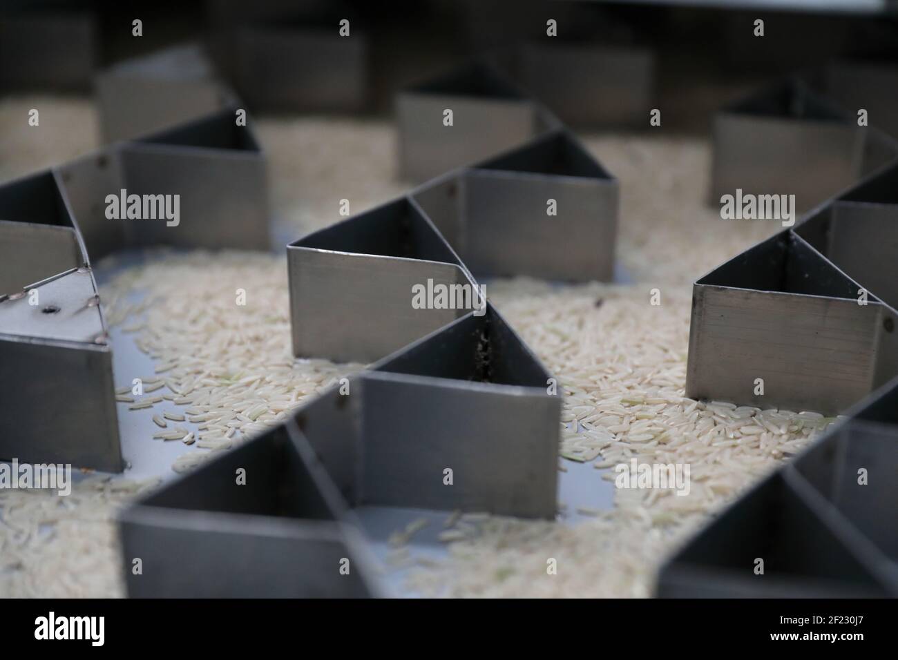 Factory machine Milling rice in close up Stock Photo - Alamy