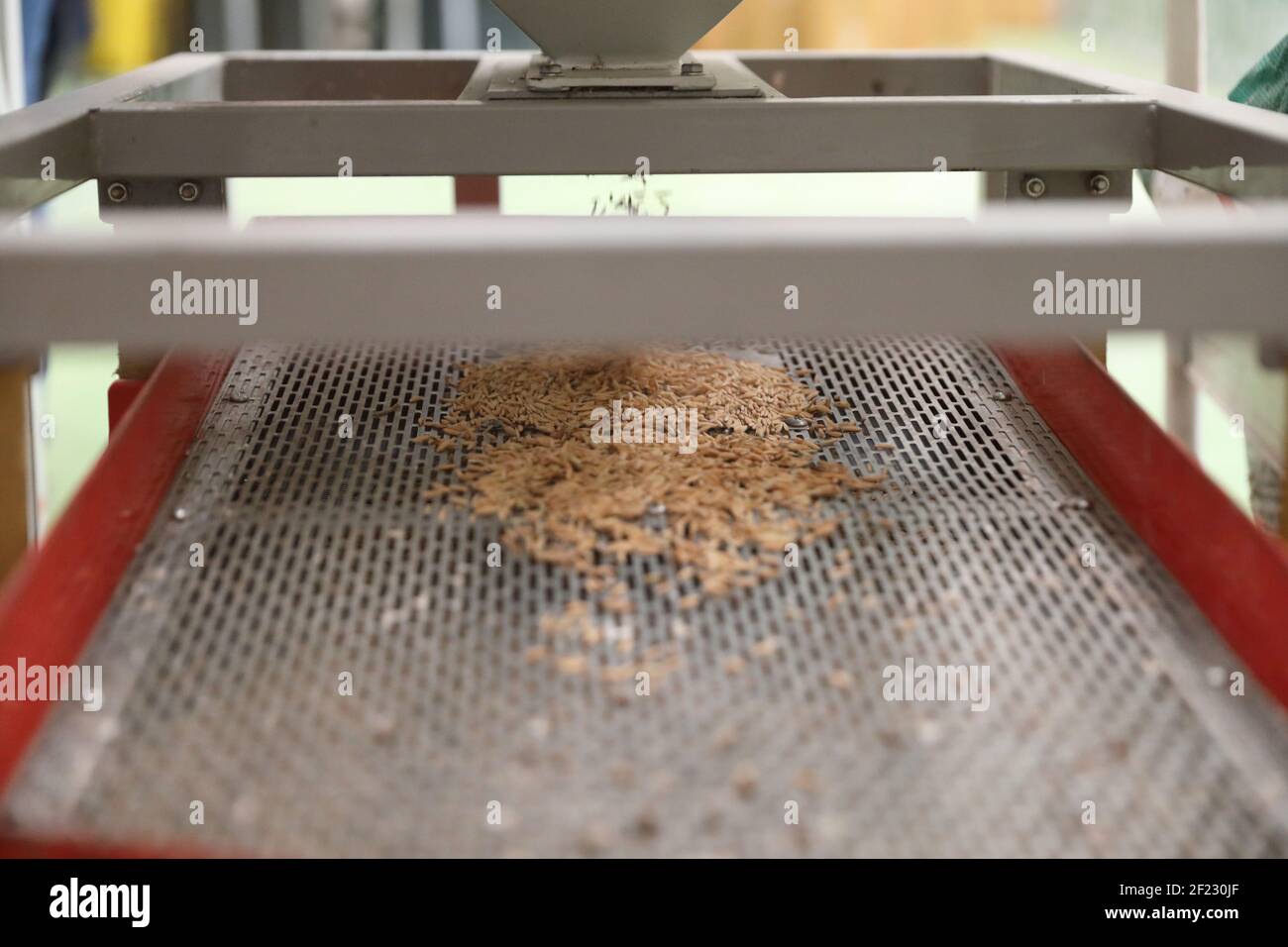 Factory machine Milling rice in close up Stock Photo - Alamy