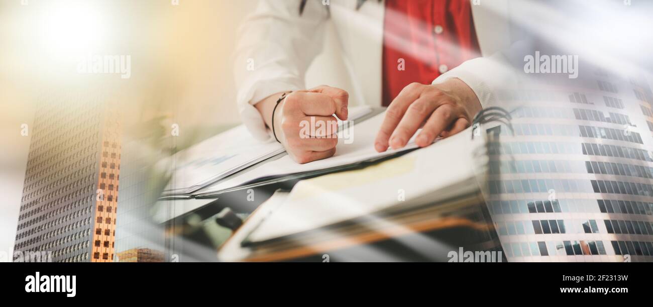 Angry businesswoman hitting her desk with her clenched fist; multiple ...
