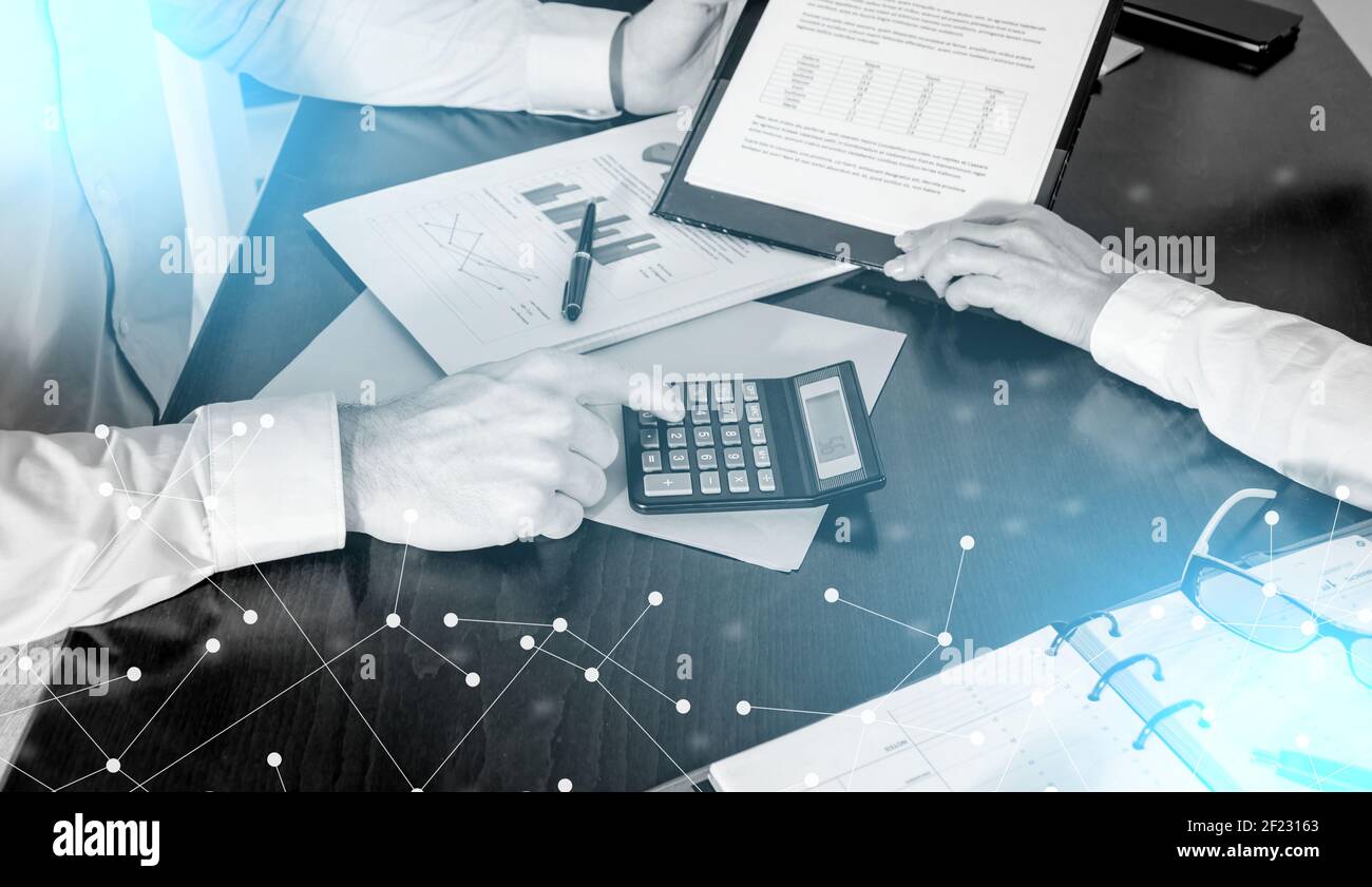 Two business people analyzing results; light effect Stock Photo - Alamy