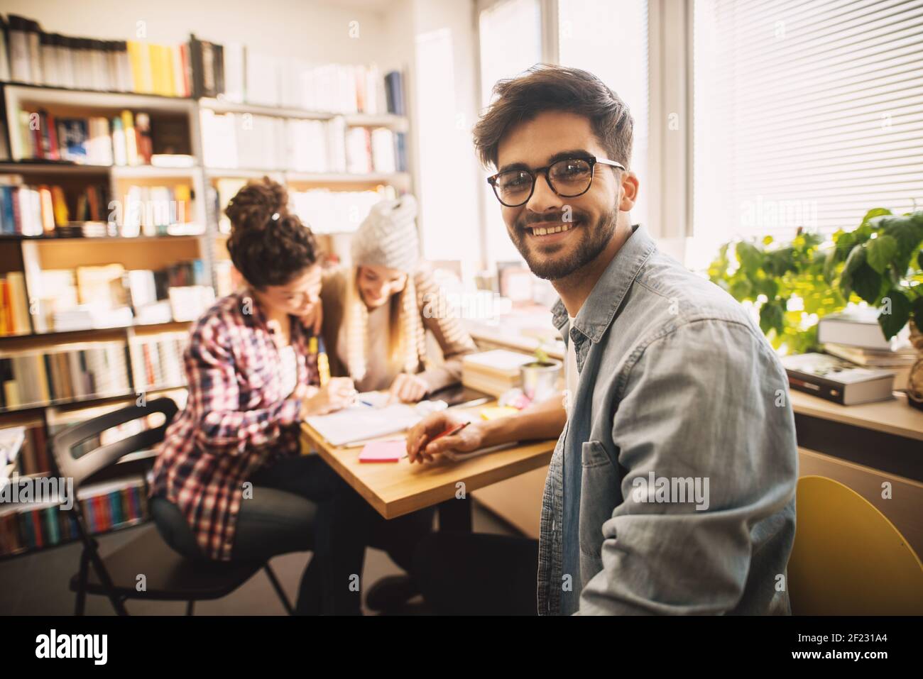 Portrait view of handsome nerdy smart young man with glasses doing ...