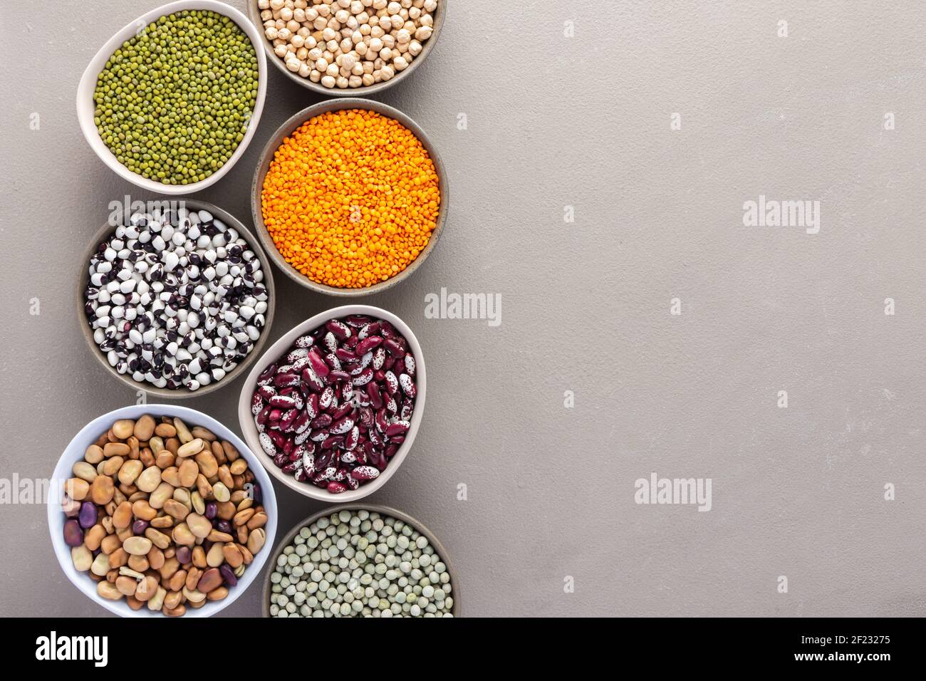 Different types of legumes in bowls, green and yellow peas, chickpeas ...