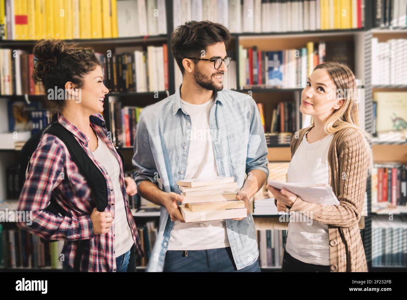 Three college students standing talking hi-res stock photography and ...