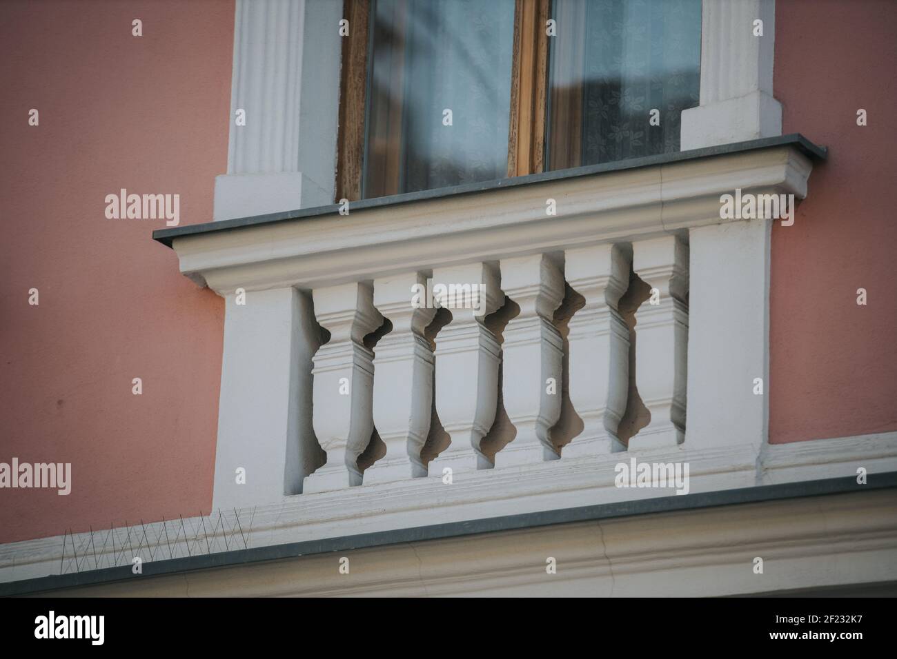 A balcony of an old building with white balusters Stock Photo - Alamy