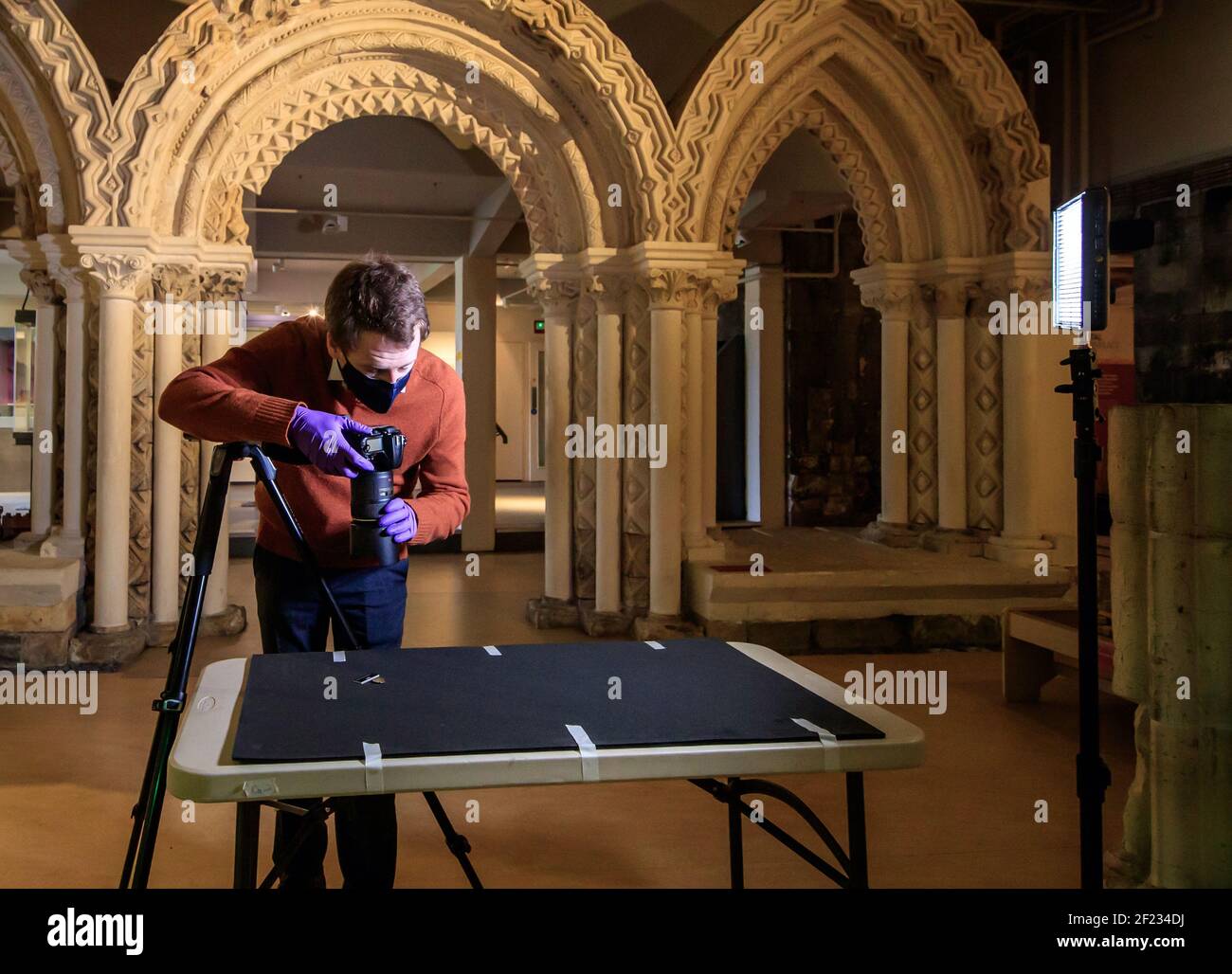 Andrew Woods, senior curator at the Yorkshire Museum, photographs a ...