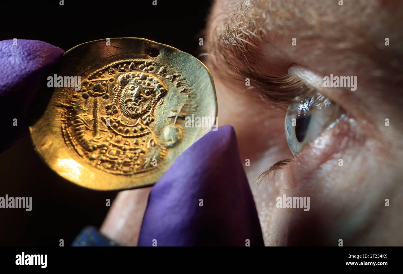 Andrew Woods, senior curator at the Yorkshire Museum, holds a gold coin ...