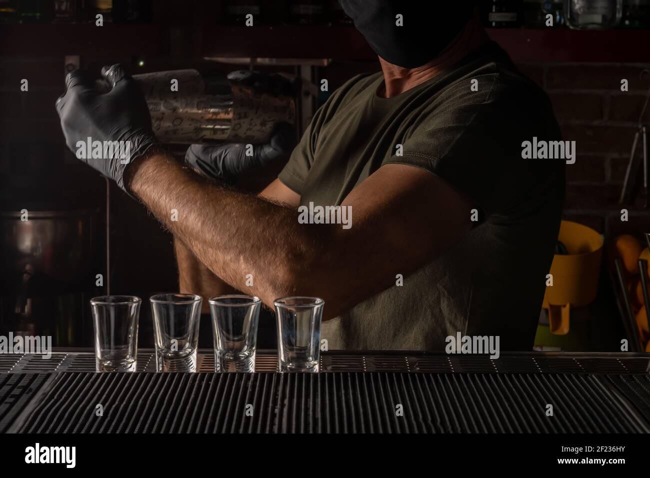 Barman in the bar shaking and mixing alcohol cocktail. Summer party ...