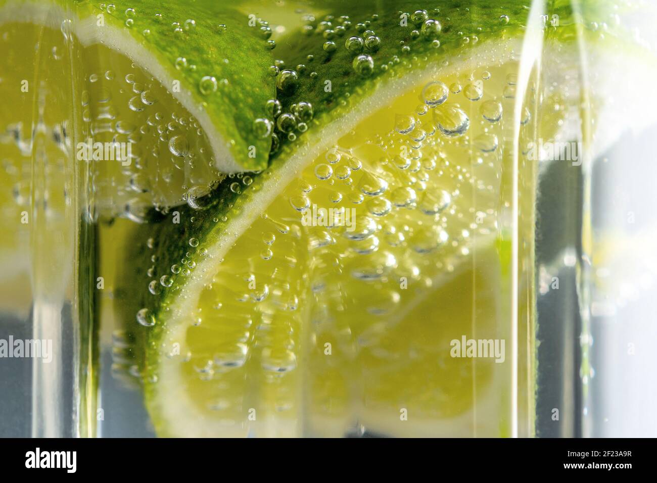 Fresh lime slice with juice drops background hi-res stock photography ...