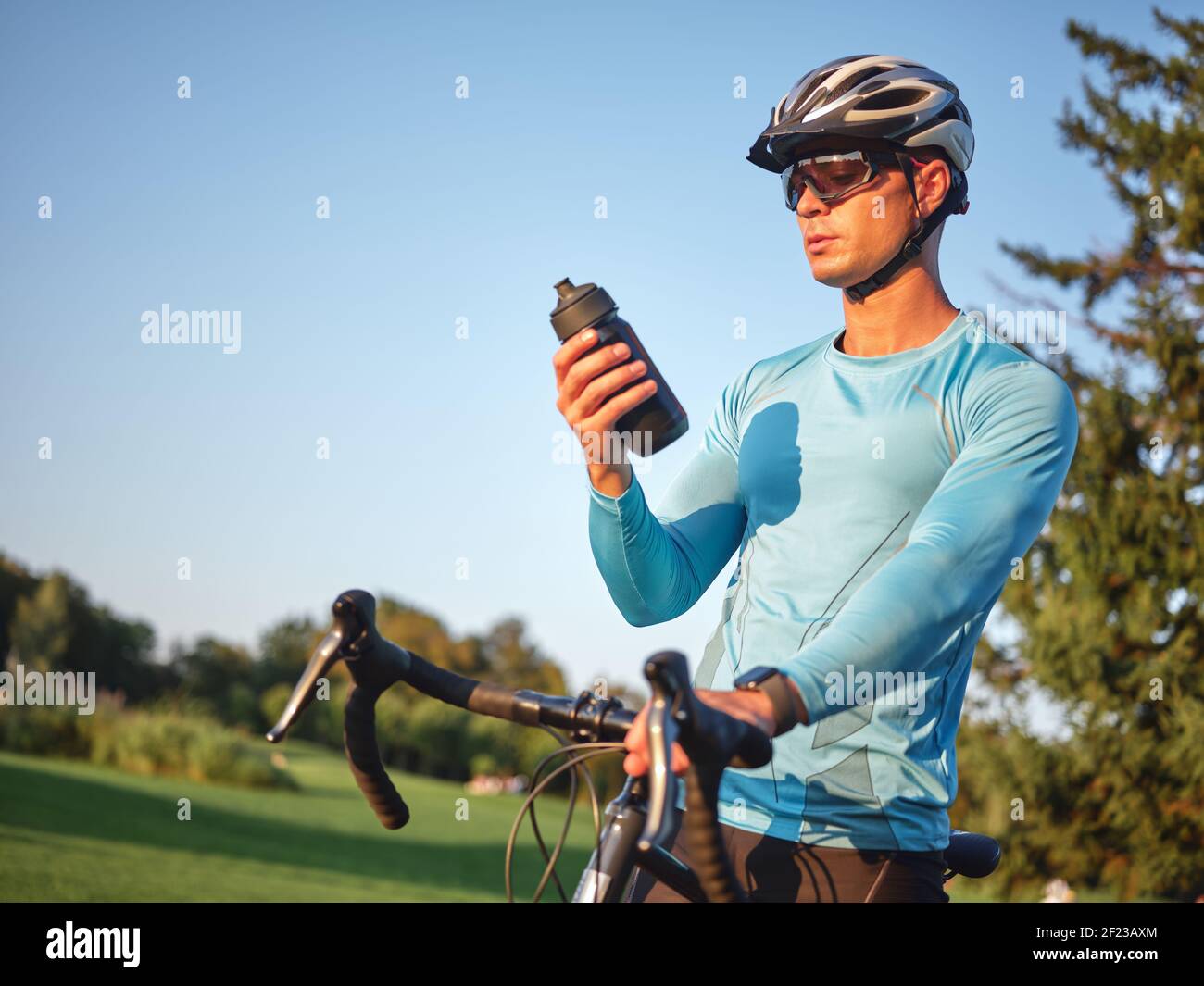 Handsome cyclist drinking water hi-res stock photography and images - Alamy