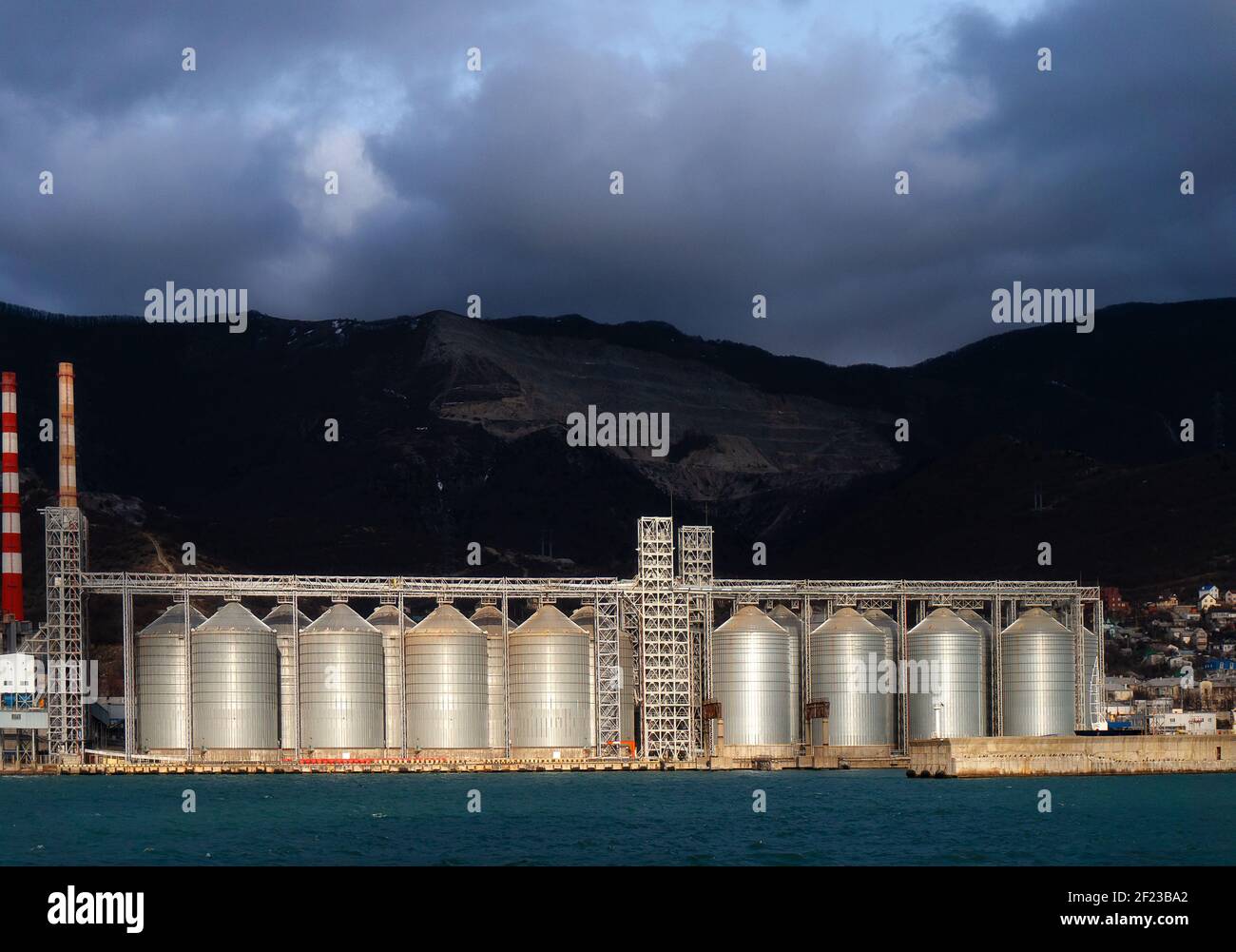 cisterns for storing grain in the port by the sea against the backdrop ...