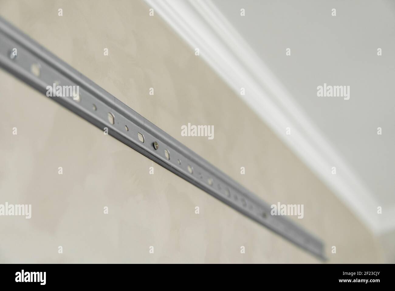 Close-up of stainless steel mounting rail for mounting kitchen cabinets ...