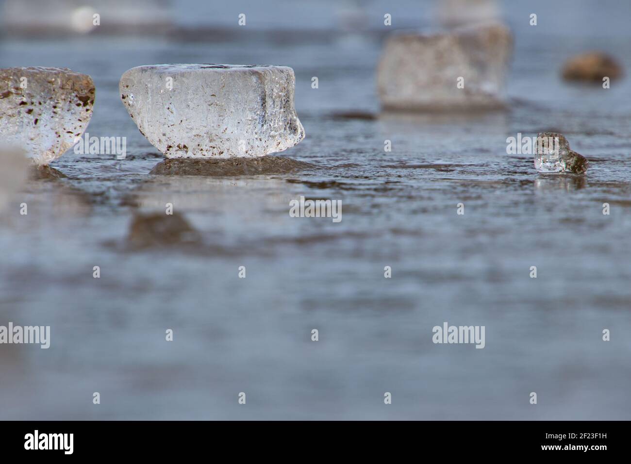 Side view of ice block laying on ice surface, selective focus Stock ...
