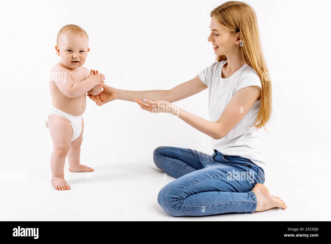 Little child taking the first steps, Happy little child learning to ...