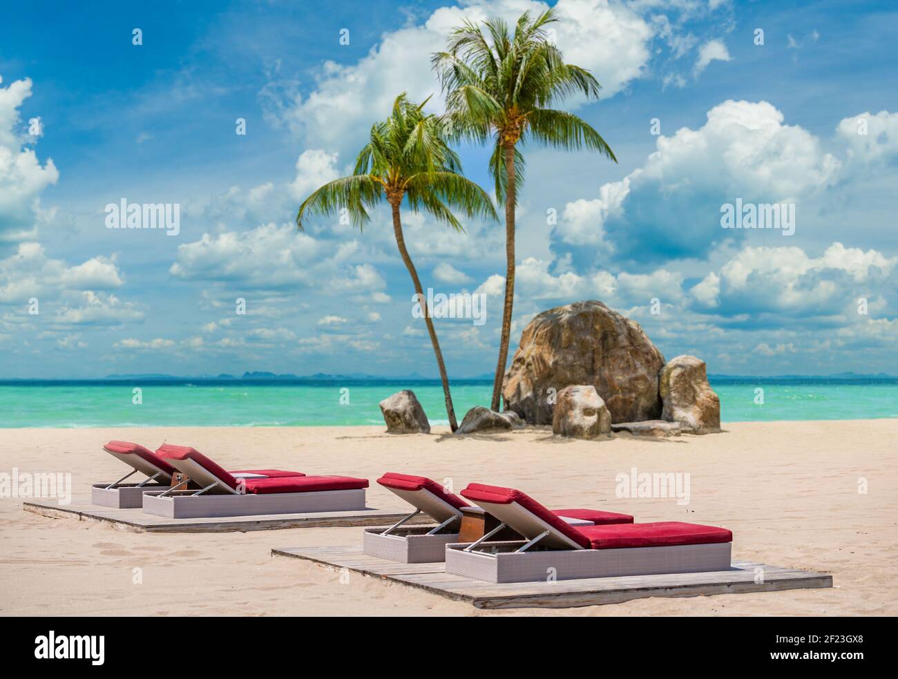 Sunbeds at the tropical beach Stock Photo - Alamy