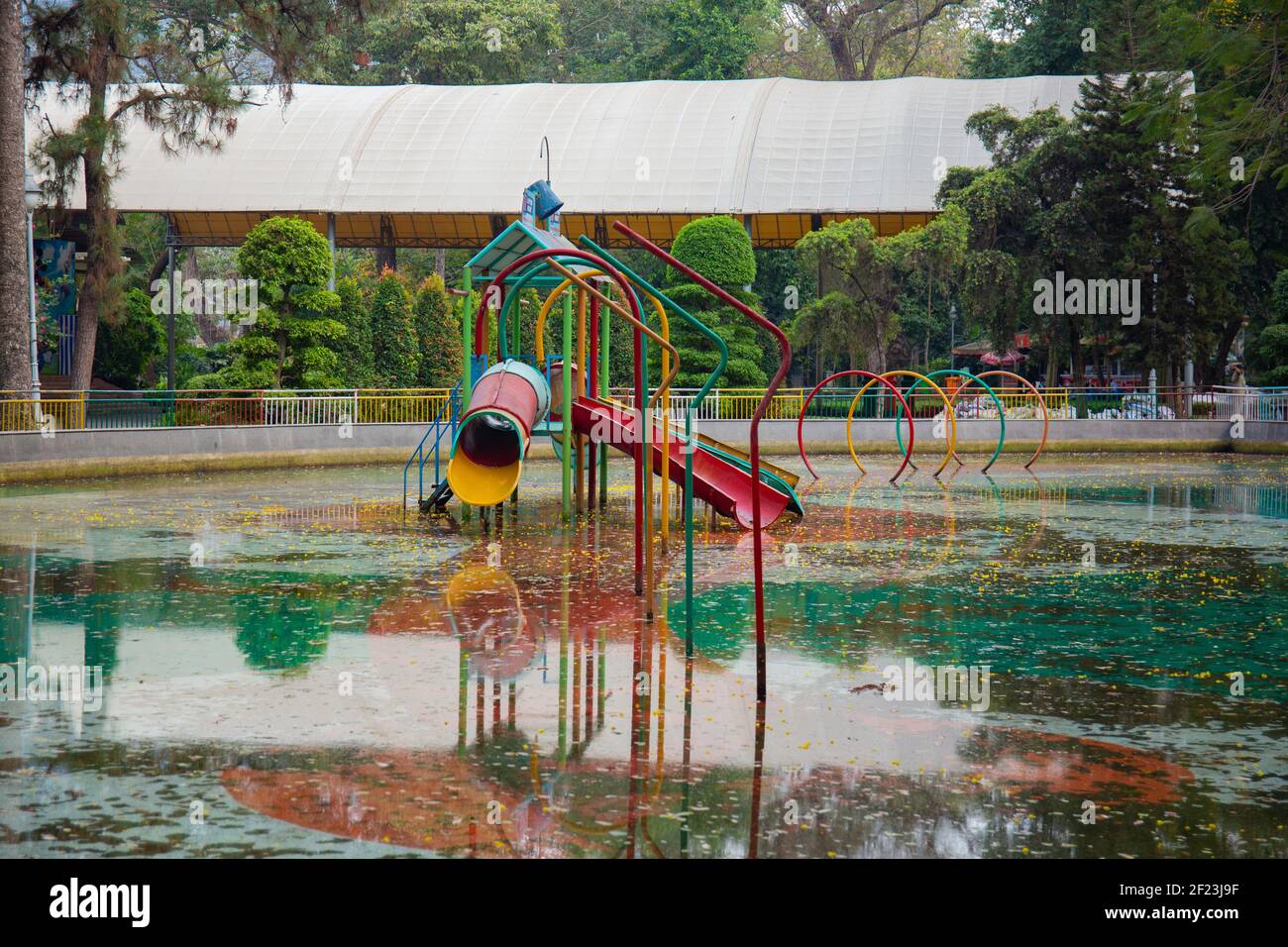 A park with a lake and playground slides Stock Photo - Alamy