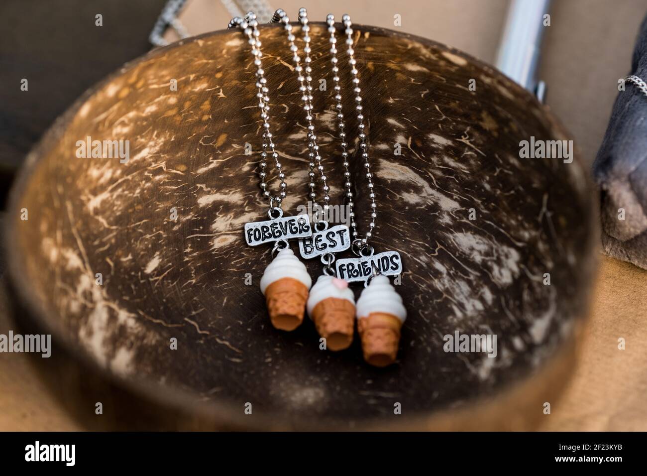 Best friends forever necklace pendant shoot outside in a summer day ...