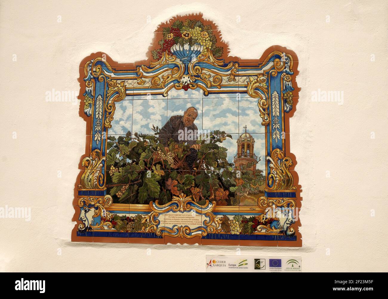 Mural in tiles showing a man picking grapes with the tower of the ...