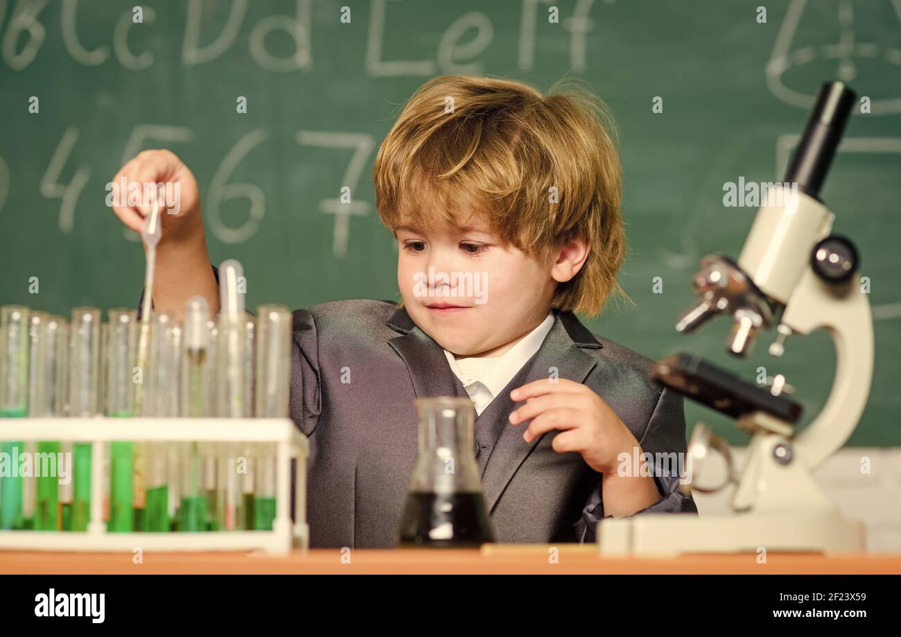 small boy using microscope at lesson. microscope at lab. Back to school ...