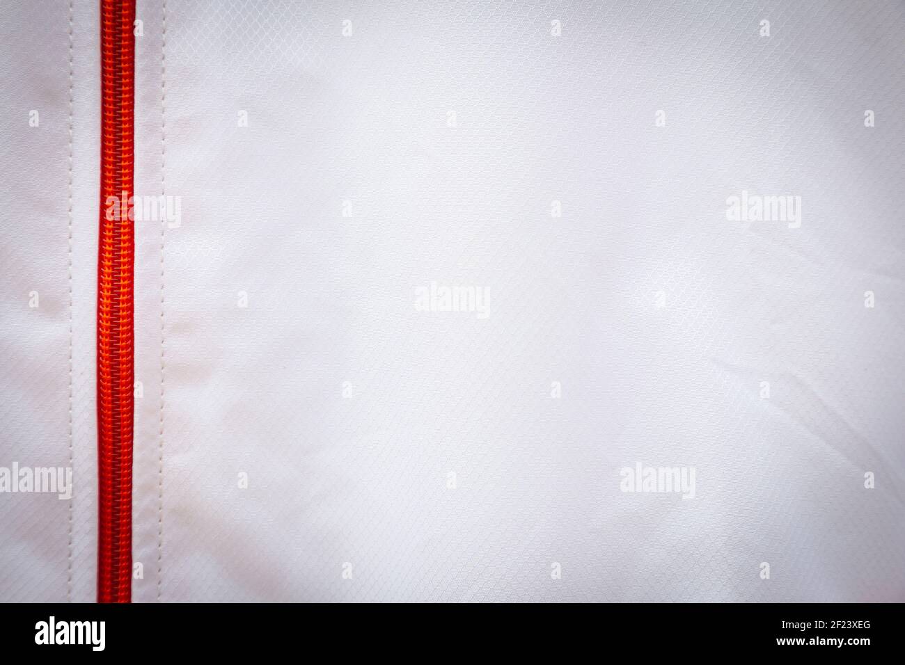 White textured nylon fabric pattern background with orange zip for ...