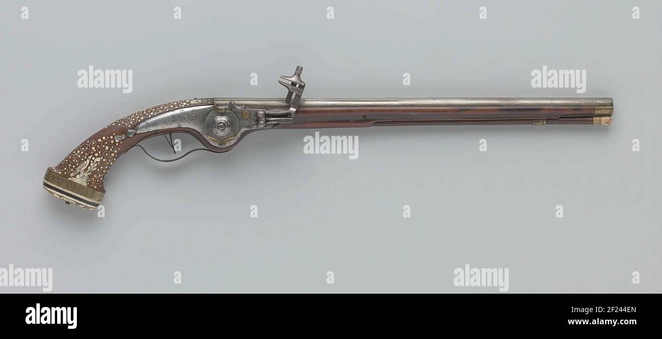 Wheellock pistol.On the lockplate on the side of this pistol is a ...