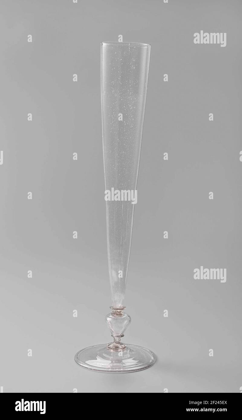 Flute glass.Flute glass on flat foot with beaten edge. The stem made up ...