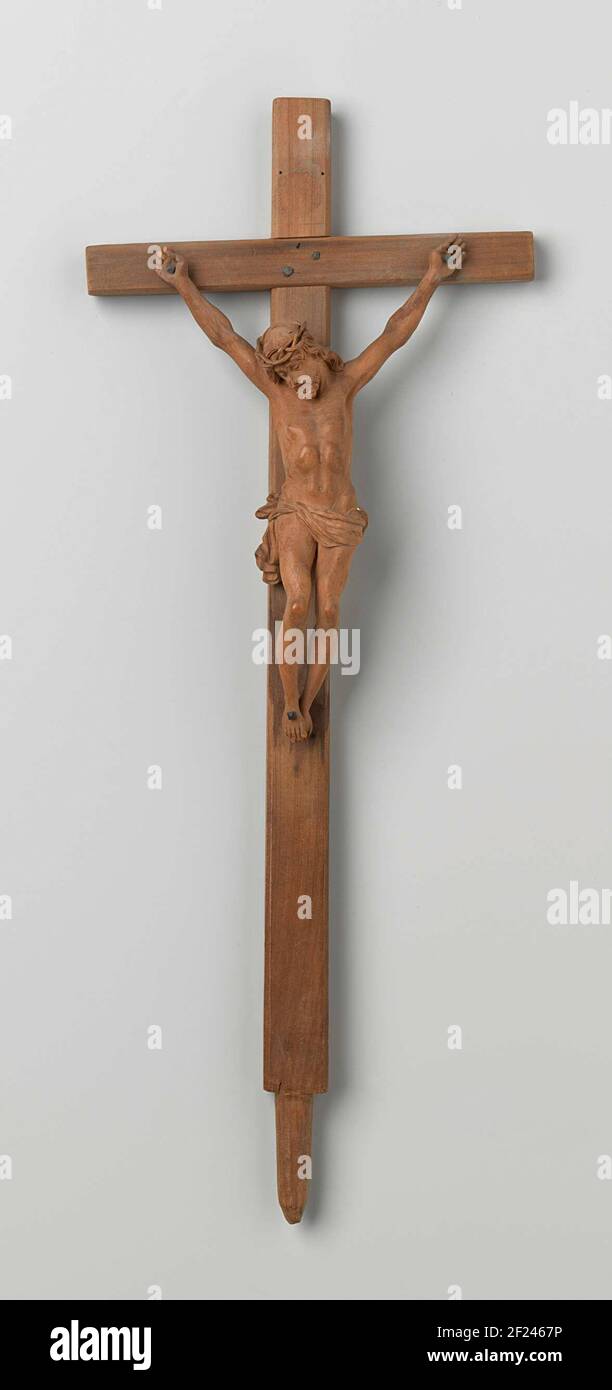 Kruisbeeld.The head with thorn crown hangs to the left. The right foot ...