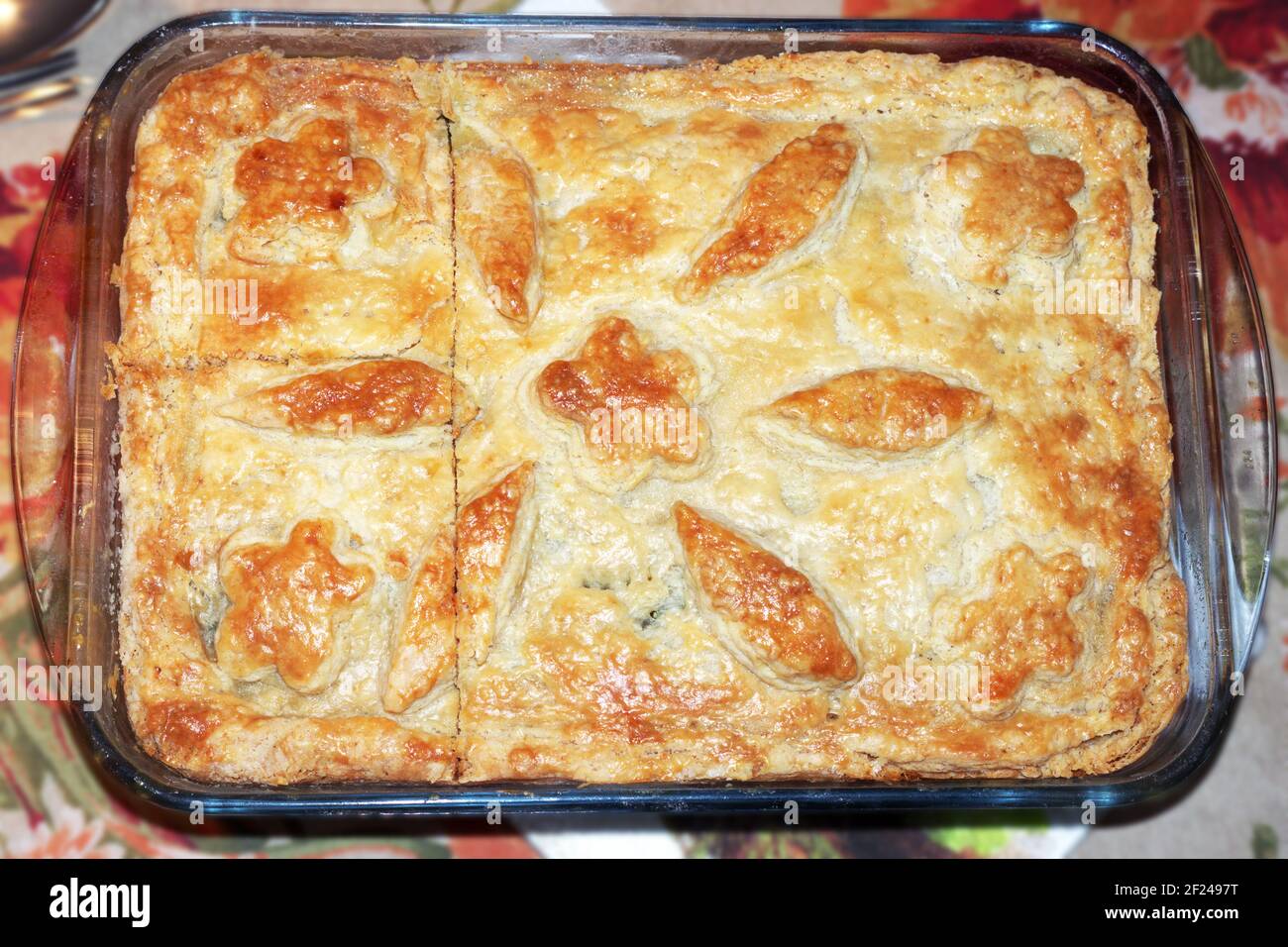 homemade meat pie with golden crust, decorated with ornament of dough ...