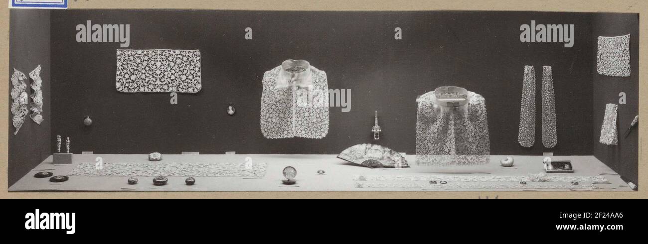 Showcase with various objects including two collars and a range ...