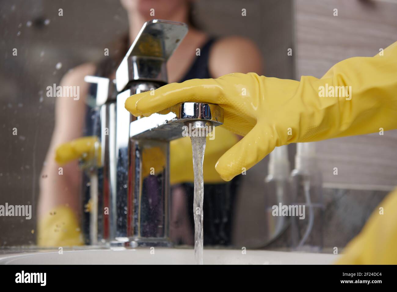 washing hands in yellow rubber gloves with water Stock Photo - Alamy