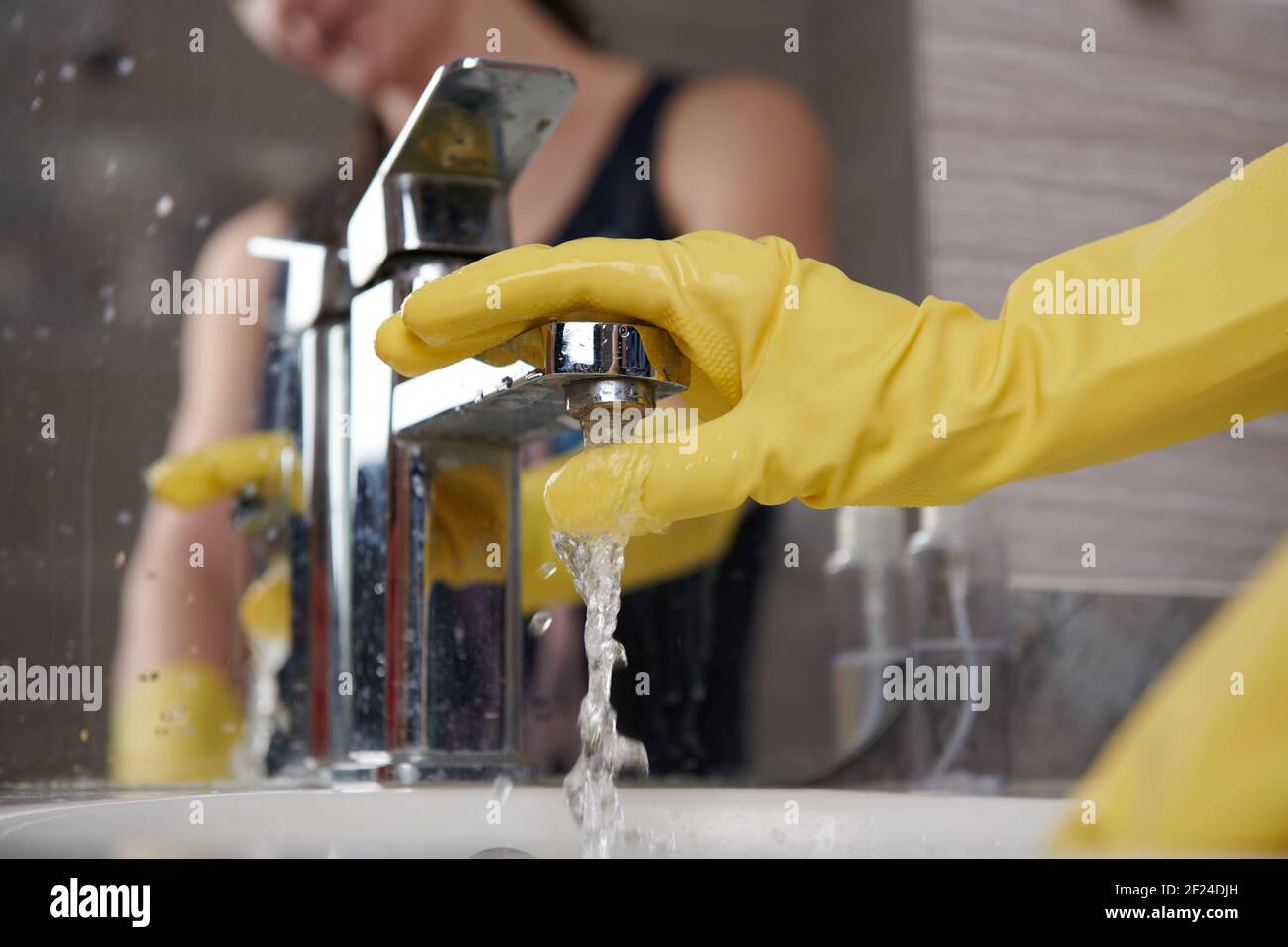washing hands in yellow rubber gloves with water Stock Photo - Alamy