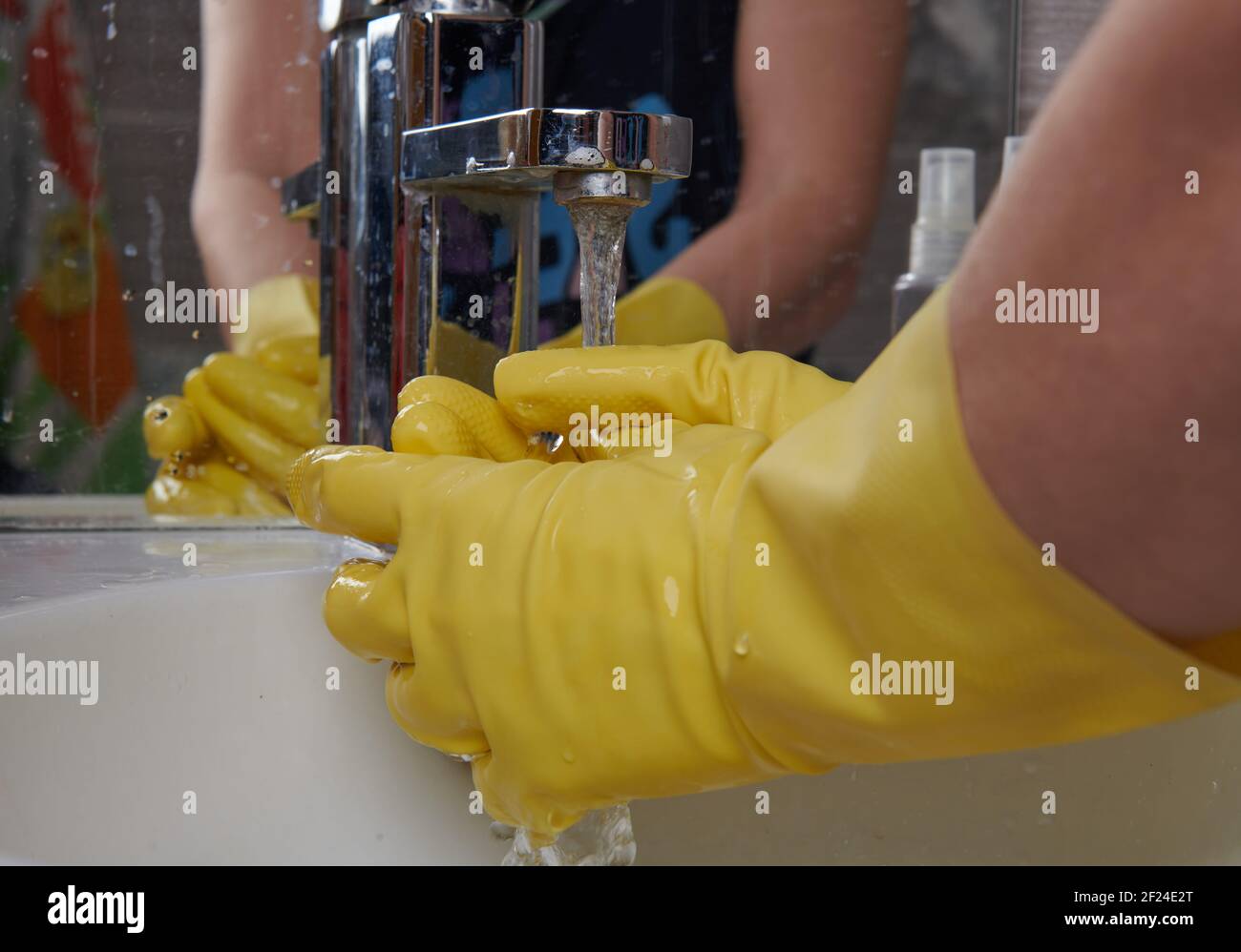 washing hands in yellow rubber gloves with water Stock Photo - Alamy