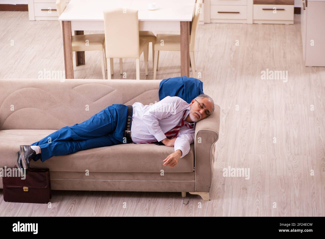 Old male boss employee coming home from work Stock Photo - Alamy