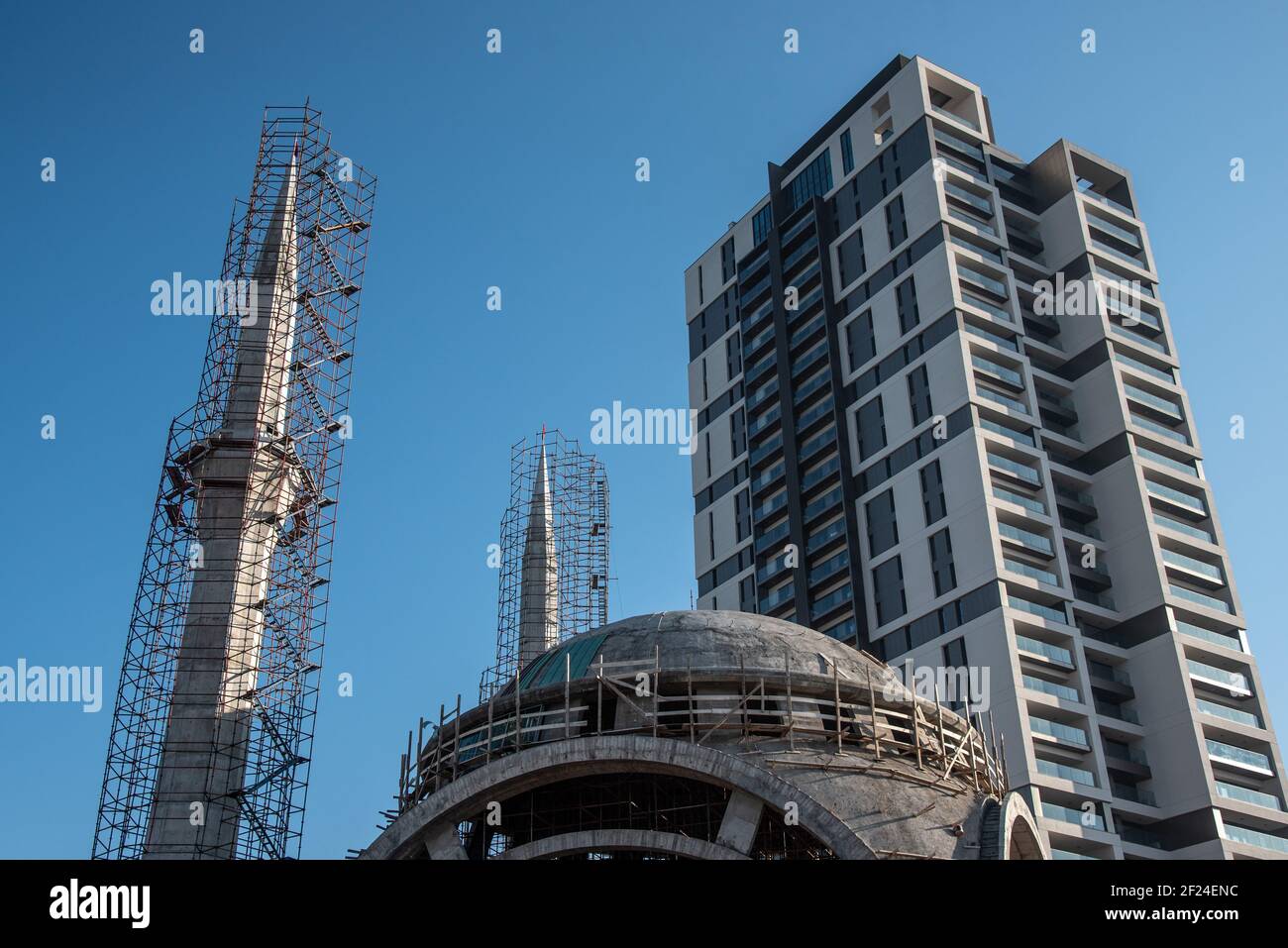 Mosque construction next to a high-rise multi-storey building Stock ...