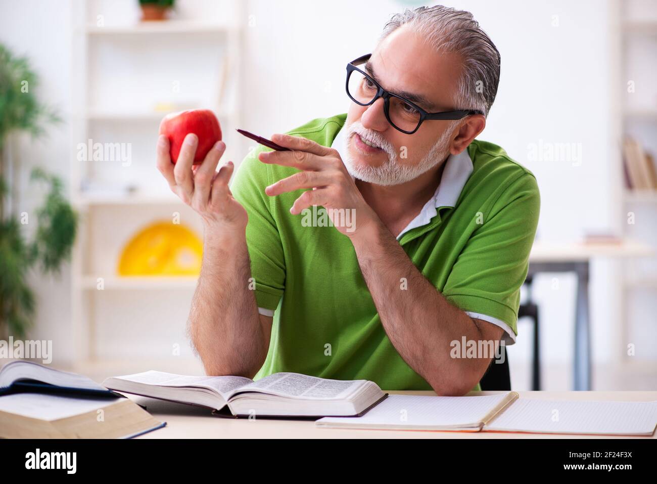 Male teacher eating apple hi-res stock photography and images - Alamy