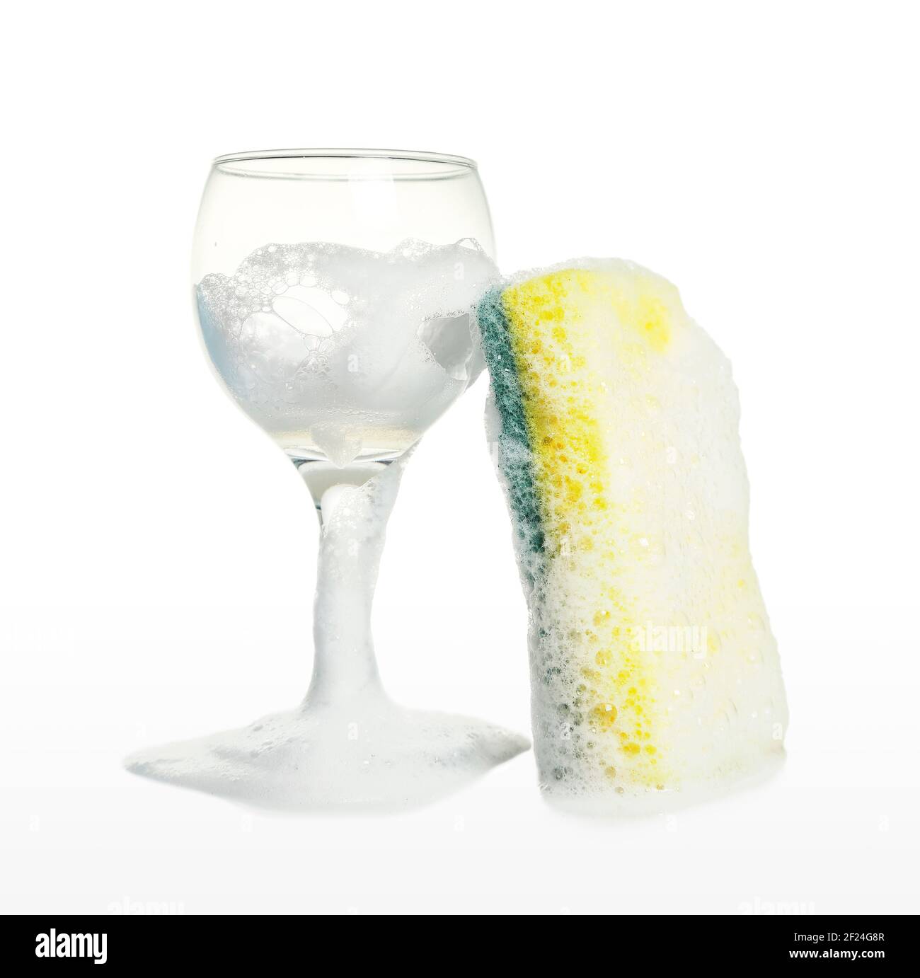 wine glass with kitchen sponge in foam isolated on white Stock Photo ...